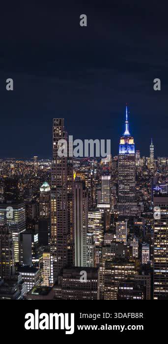 Vertical night view of New York City skyline with the illuminated ...