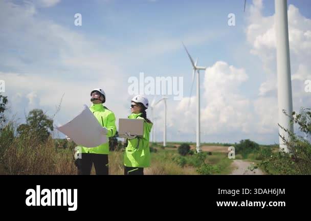 Engineers wearing safety helmets and reflective jackets inspecting a ...