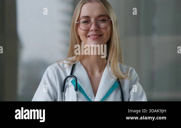 Caucasian happy smiling woman doctor showing heart shape cardiologist ...