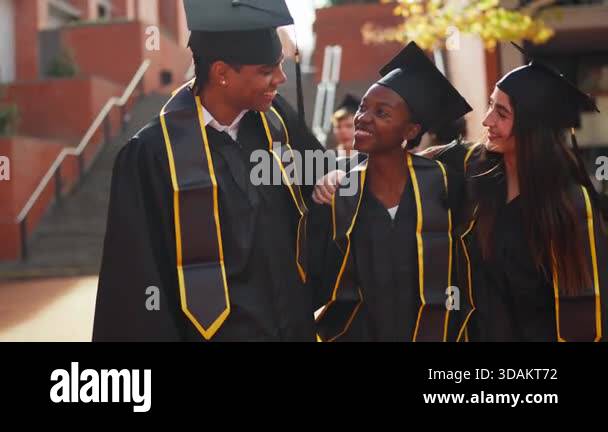 Group of diverse graduate students in gowns and caps celebrating their ...