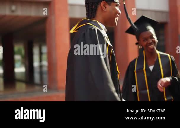 Young female graduate running to hug her male friend during the ...