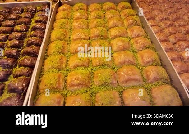 People are buying and tasting baklava in a busy sweet shop Stock Video ...
