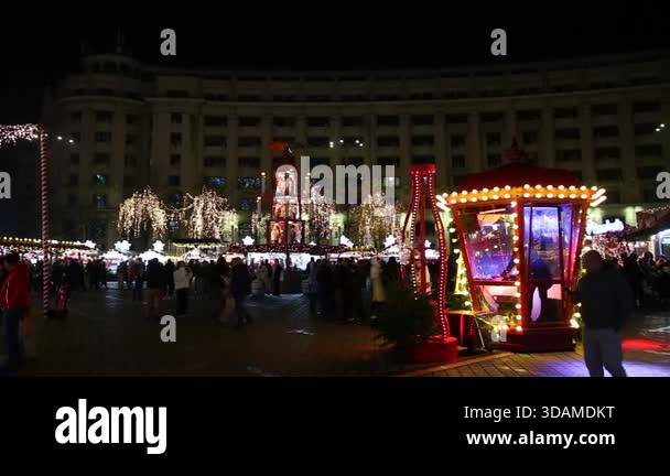 Bucharest Christmas market at night with decorated tree, colorful ...