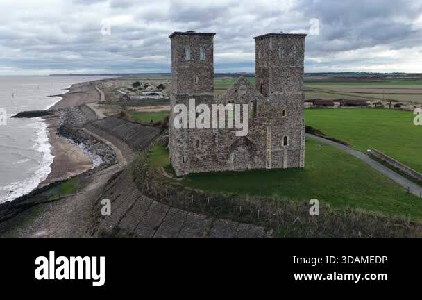 Aerial close-up drone video of the Reculver Towers and Roman Fort along ...