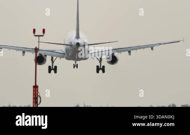 Commercial aircraft landing and braking, slowing down, rear view. Jet ...