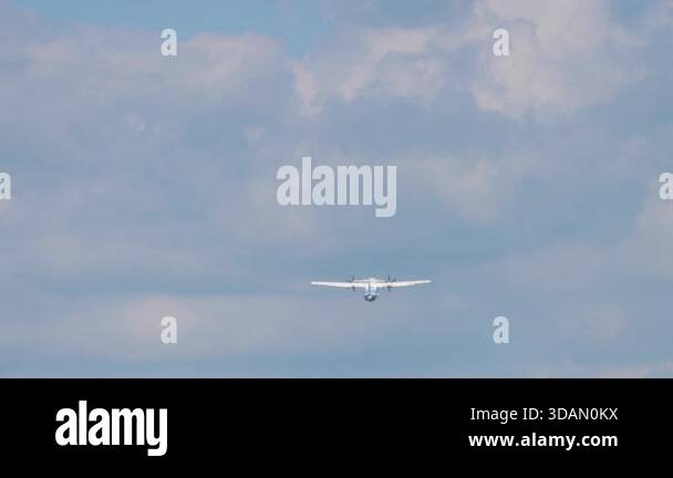 Footage of airplane gaining altitude in blue cloudy sky, rear view ...