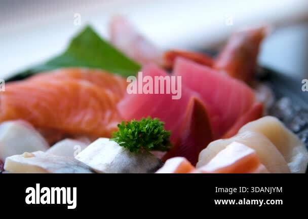 A vibrant Japanese sashimi platter with salmon, tuna, scallop, and ...