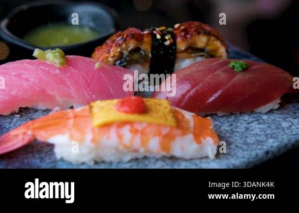 overhead closeup 4K chef hands plating nigiri sushi assortment. High ...