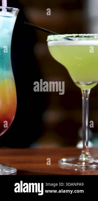 Colorful cocktails bar Slow Motion Shot of Pouring Long Drink Into ...