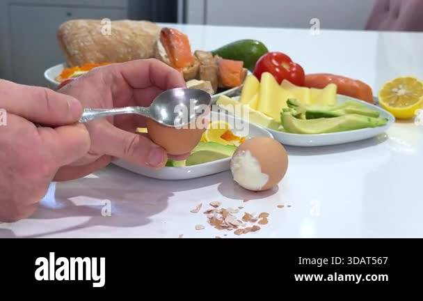 Overhead view of fair skinned person focused on peeling shell off ...