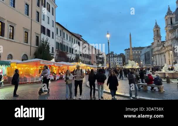 evening scene at Piazza Navona in Rome featuring iconic fountain lively ...