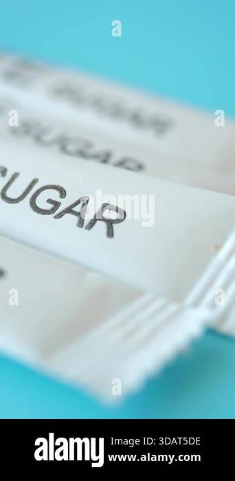 Sugar packets are shown on a blue table with clear labels Stock Video ...