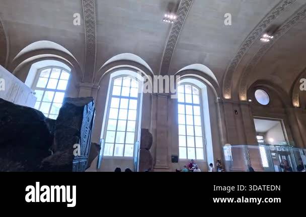 Visitors admire art in Louvre Museum Stock Video Footage - Alamy