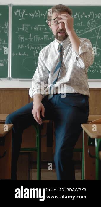 Math teacher explains concepts to students in an engaging classroom ...