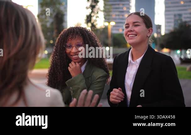 A joyful moment captured as three women engage in an animated ...