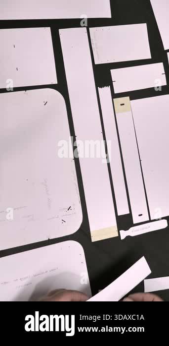 A close-up of a paper pattern or template. The dark lines and precise ...