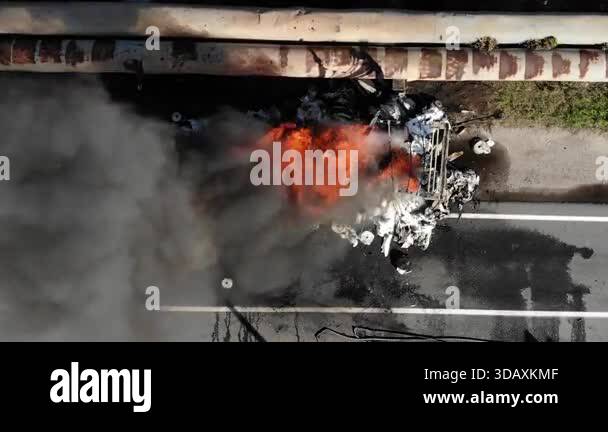 Aerial view from a drone: Firefighters extinguish a large fire on the ...