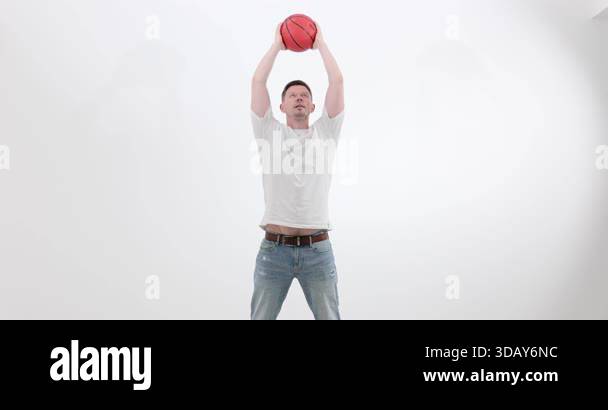 Man exercises with basketball ball on white background slow motion ...