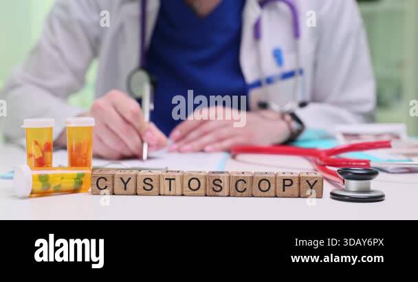 Wooden blocks spell word Cystoscopy near pill containers on table ...