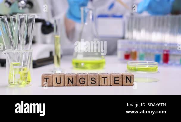 Wooden blocks spell word Tungsten on chemistry laboratory bench ...