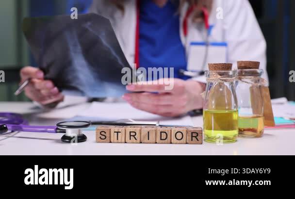 Wooden blocks spell word Stridor near stethoscope and glass bottles on ...
