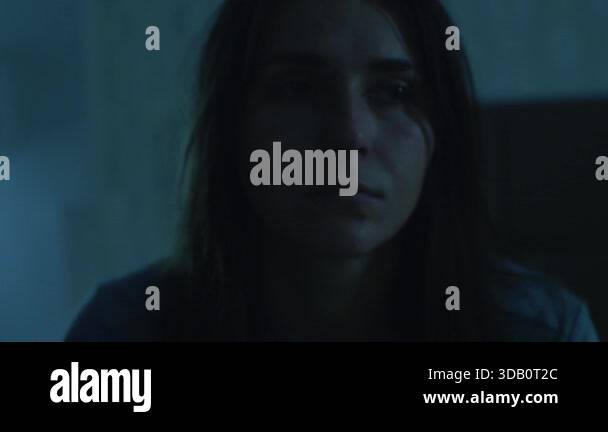 A disoriented woman touches her face, trying to steady herself before ...