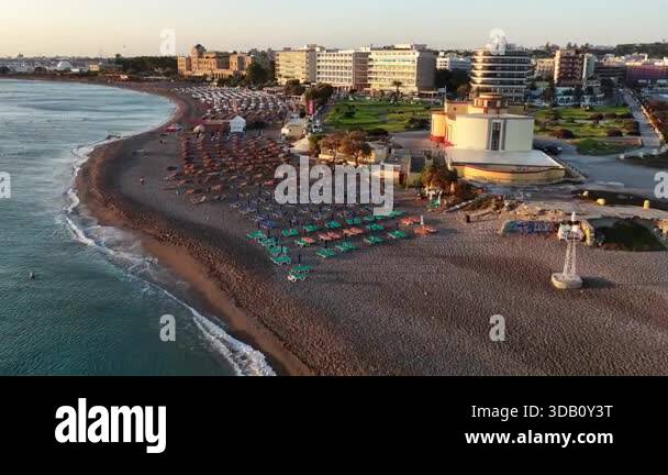 An aerial perspective reveals Ixia Beach at sunset. View the shore with ...