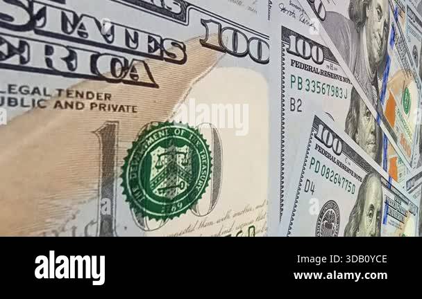 Aerial movement across detailed 100 dollar bills creating an exclusive ...