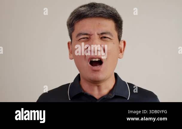 Front view of male person with painful facial expression reacting to ...