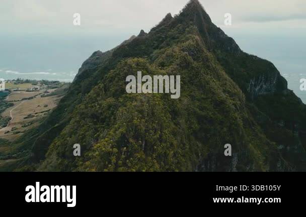 Aerial Hawaii Solitary Triangular Peak Overlooking Ocean With Grassy Slopes Descending To ...