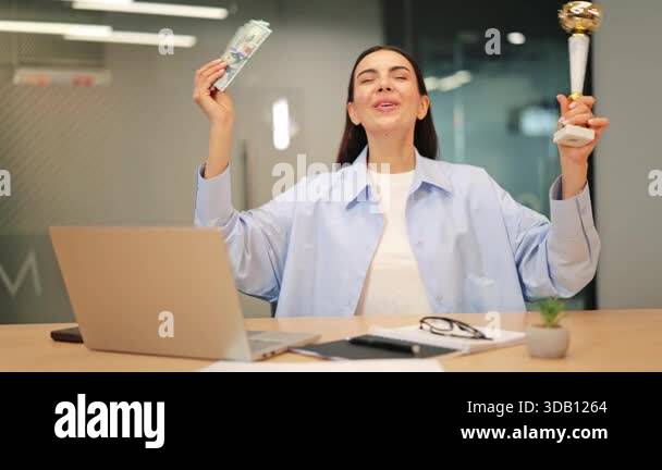 Woman overjoyed with triumph, holding money and winners trophy in ...