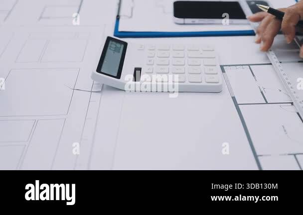 Team of architects, engineers work together reviewing architectural ...