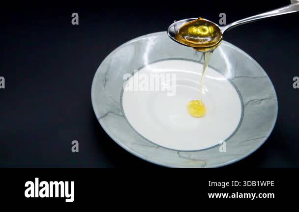 Honey Dripping from Spoon into Bowl in Slow Motion Stock Video Footage ...