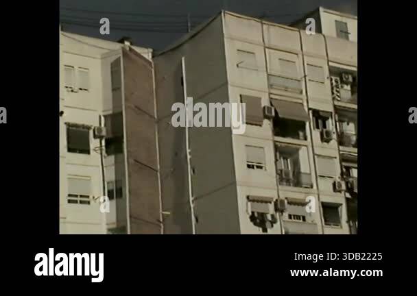Facade of old apartment building with multiple air conditioning units ...