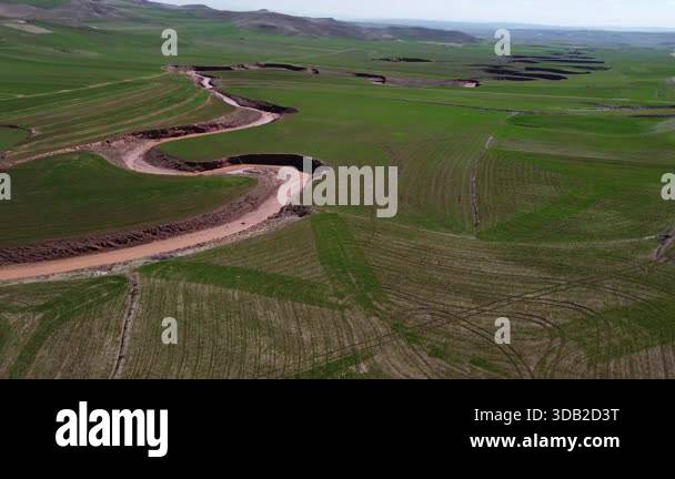 Aerial view of the river running through the fields in vast land Stock ...
