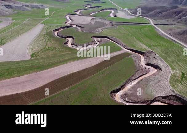 Aerial view of the river running through the fields in vast land Stock ...