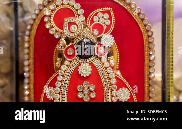 ornate deity dwarkadhish idol adorned with red velvet and sparkling ...