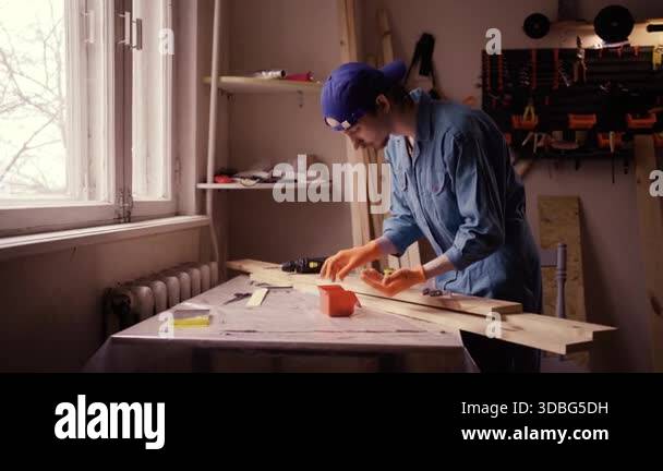 Carpenter Selecting Wood Screws For Drill Bit In Craft Workshop. copy ...