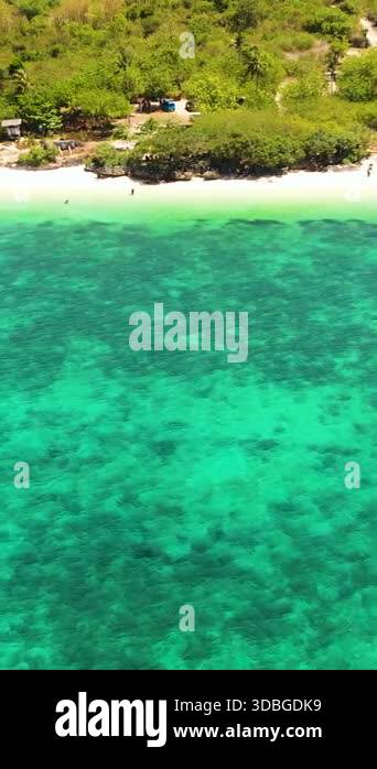 Tropical white sands in Sandira Beach. Turquoise sea water with coral ...
