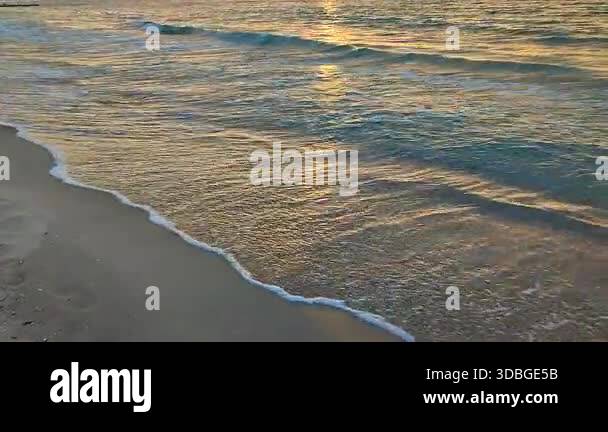 Sea waves with blue transparent water on sand of seashore. Sea waves ...