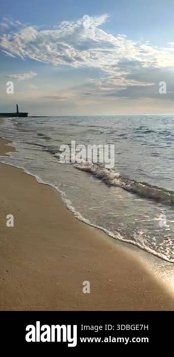 Seascape on sunny summer day. Sea waves rolling on sand of sandy beach ...