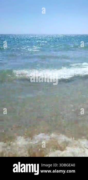 Sea waves with turquoise transparent water rolling on sand of sandy ...