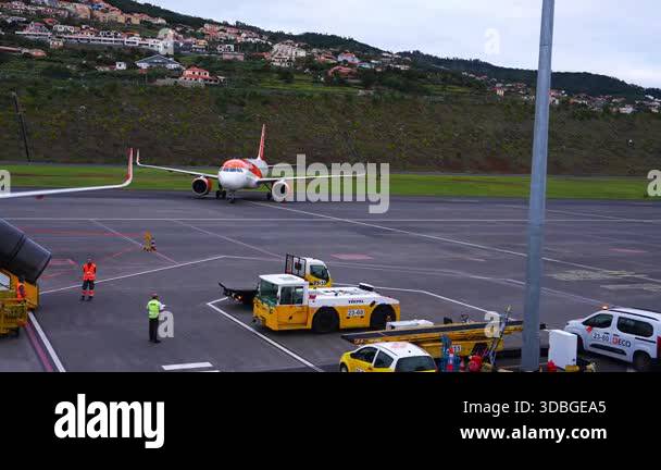 easyJet narrowbody taxis to the apron at Funchal, Madeira. Ground crews ...