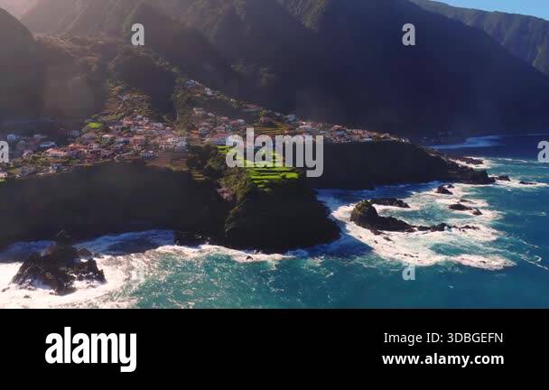 Aerial view shows a cliffside village in Madeira, Portugal, terraced ...
