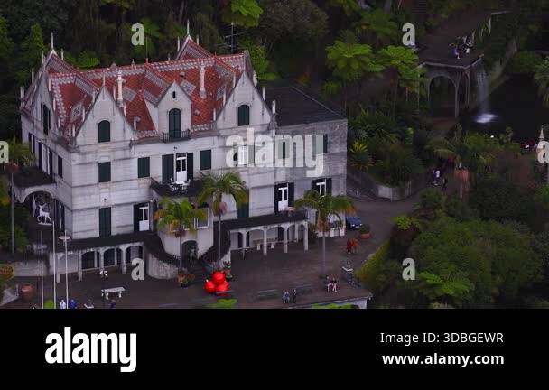 Aerial view shows Monte Palace mansion, terraces, arched waterfall ...
