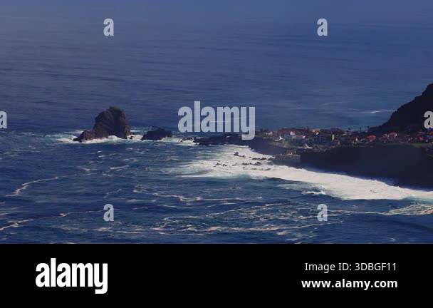 Aerial view of Madeira, Portugal, shows rugged coast, a sea stack, and ...