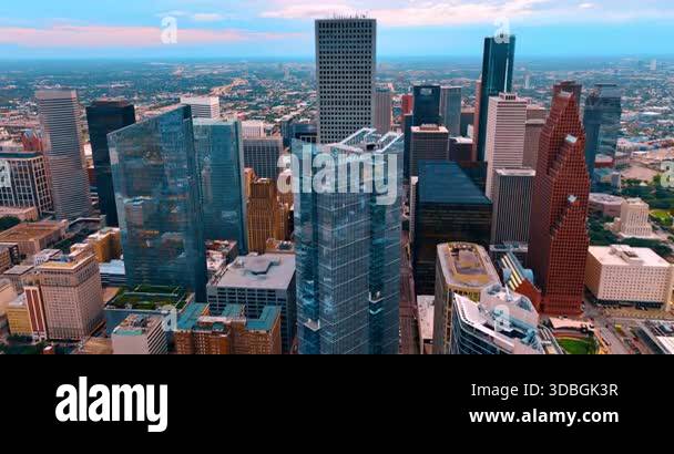Glass skyscrapers reflect the city scenery. Drone footage descending ...