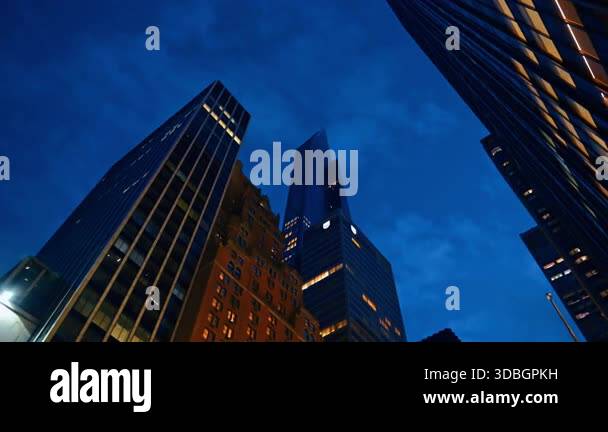 High-rises and skyscrapers of metropolis from low angle view. Light is ...