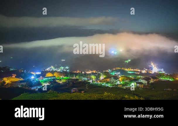 Panoramic nightscape of a mountain village surrounded by colorful ...