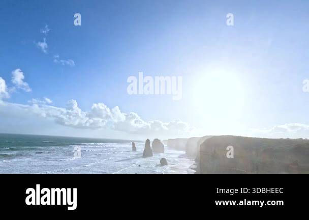 A breathtaking view of sunlit cliffs and ocean waves along the Great ...
